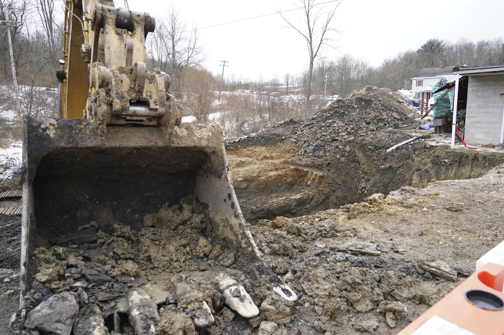 Crews recover the body of a woman from a Pennsylvania sinkhole after a ...